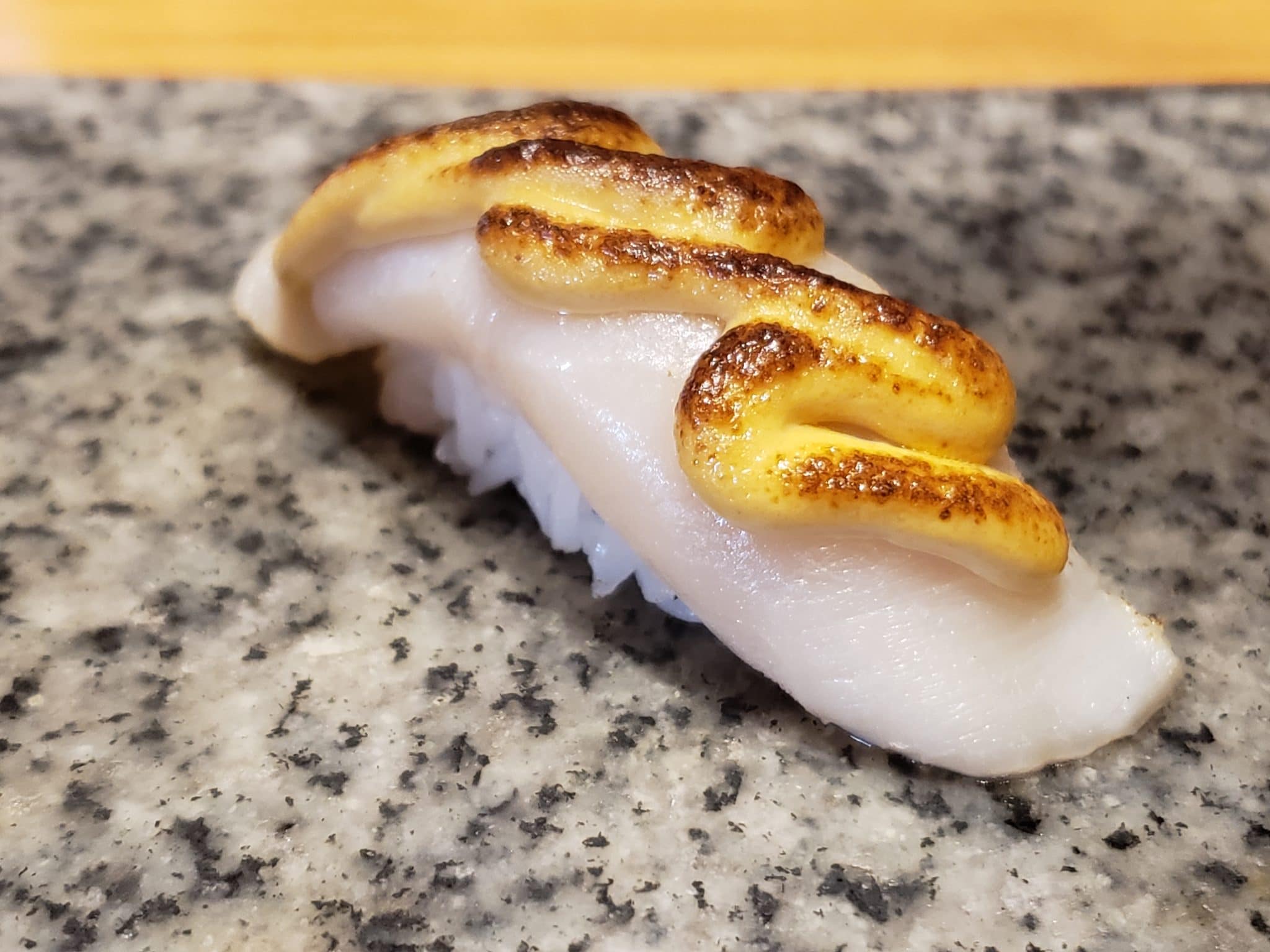 Lima Maido nigiri scallop w uni - Travel Squire